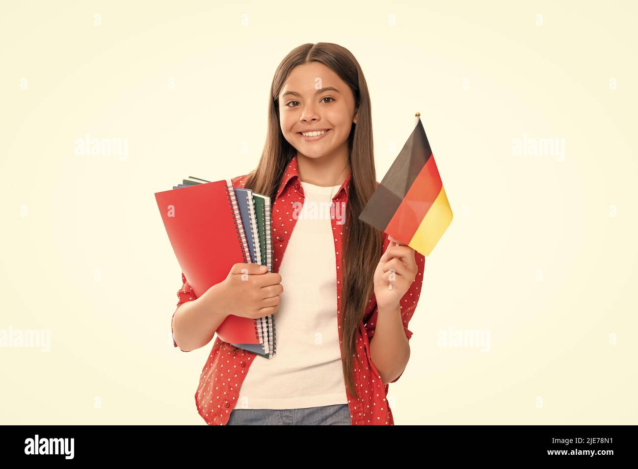 learn foreign language. happy teen girl hold german flag and workbook ...