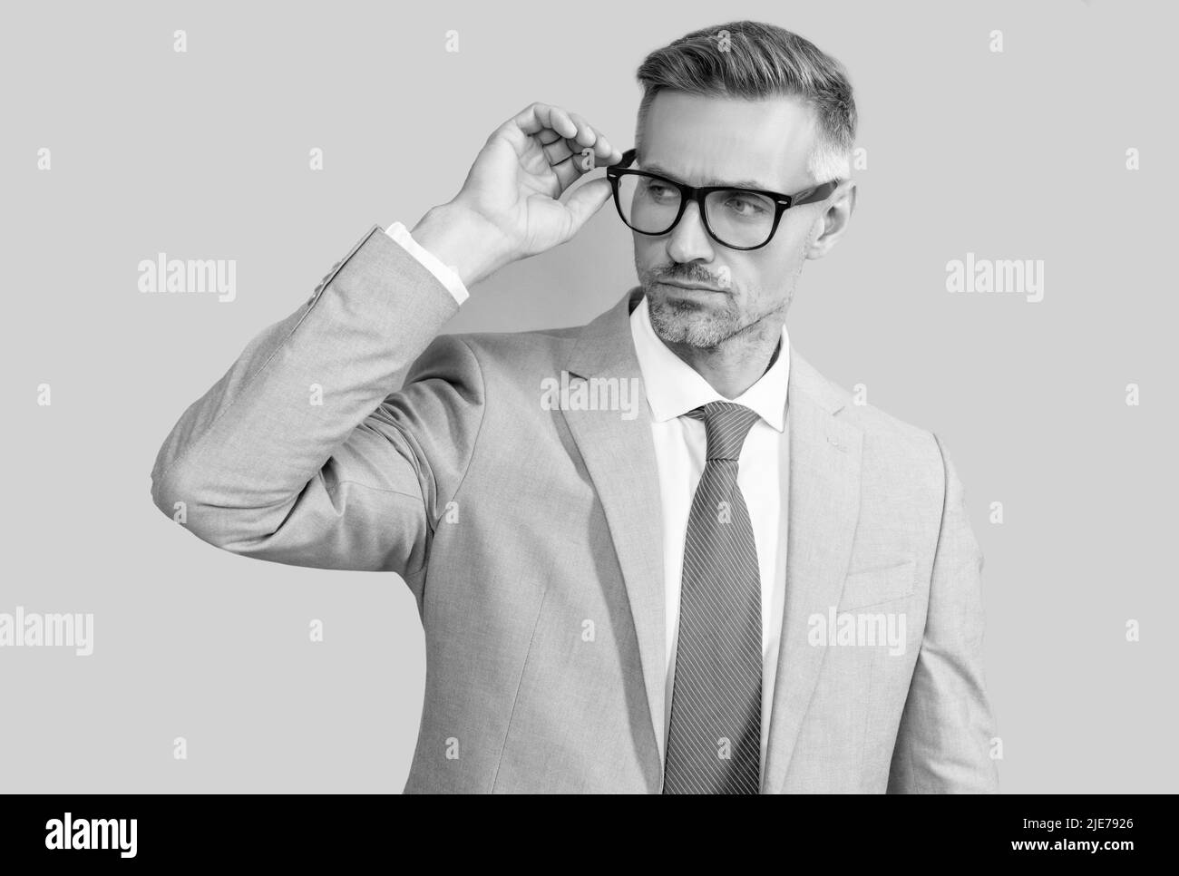 successful man in businesslike suit and glasses on grey background ...