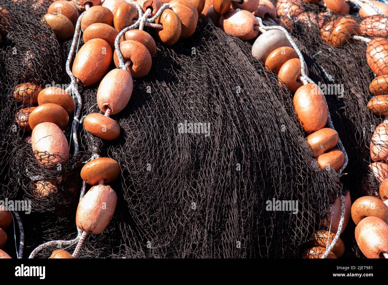 fishing net and big floats in the seaport Stock Photo - Alamy