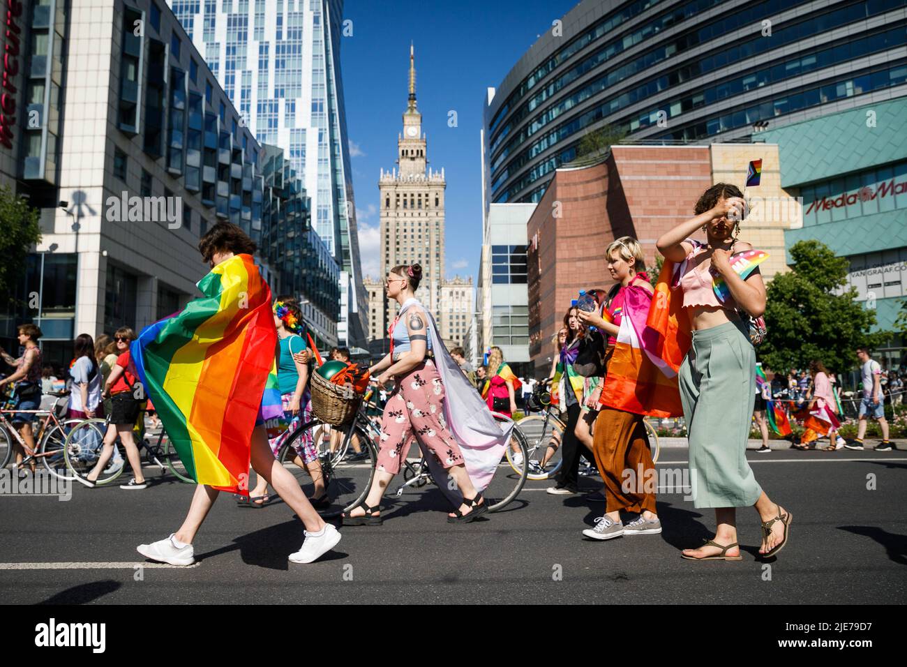 People with rainbow flags walk on the street during the Warsaw Equality ...