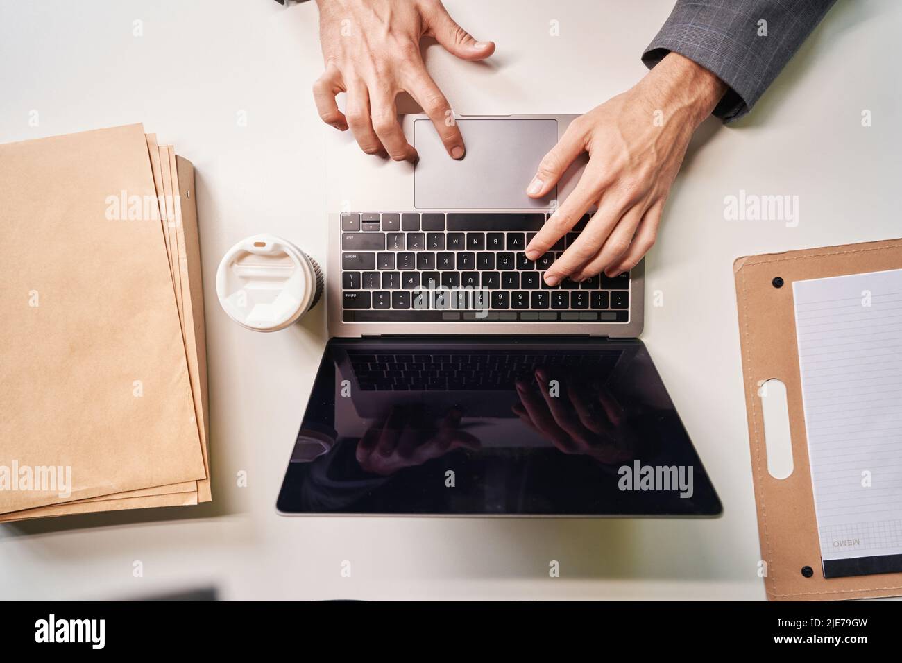 View from above of hands using keyboard of laptop Stock Photo - Alamy