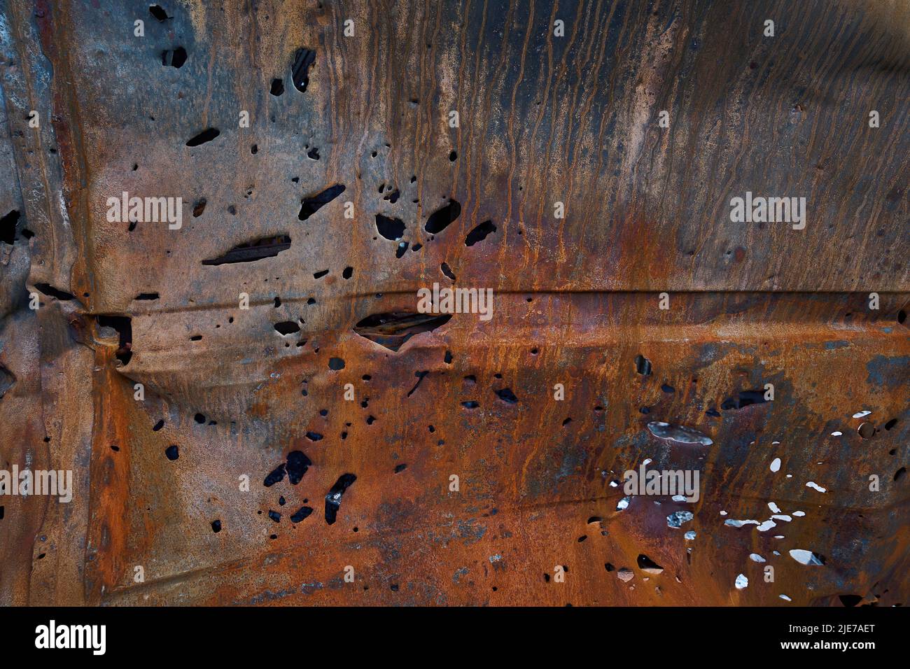 Bullet and shrapnel holes in carcass of destroyed car Stock Photo - Alamy