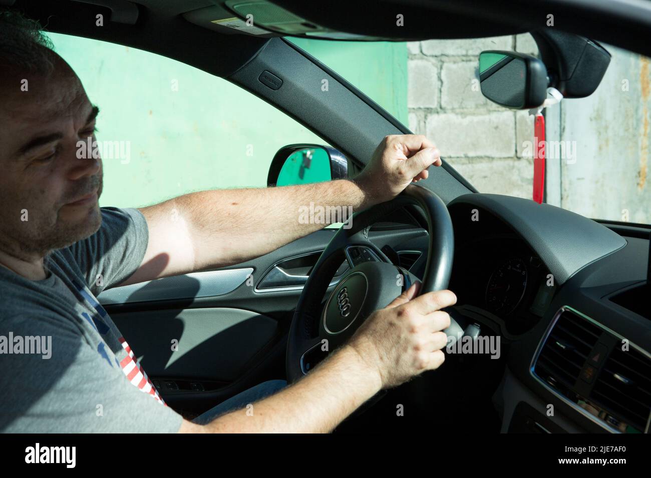 Dnepropetrovsk, Ukraine - 06.08.2022: A man driving an Audi Q3 car in ...