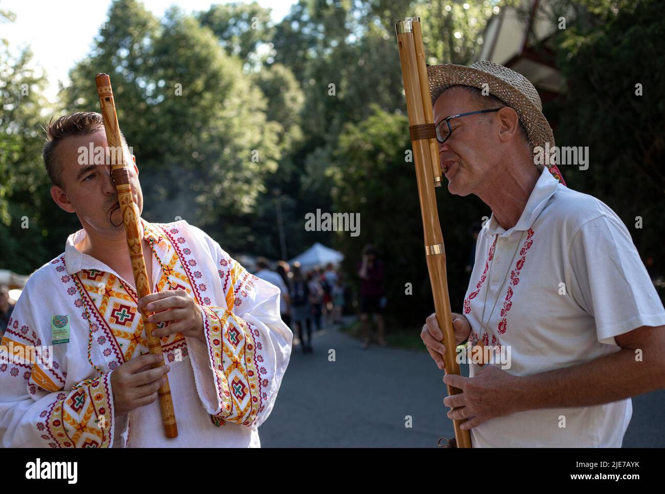 Two men are playing the flute, traditional slovakian wooden flute ...