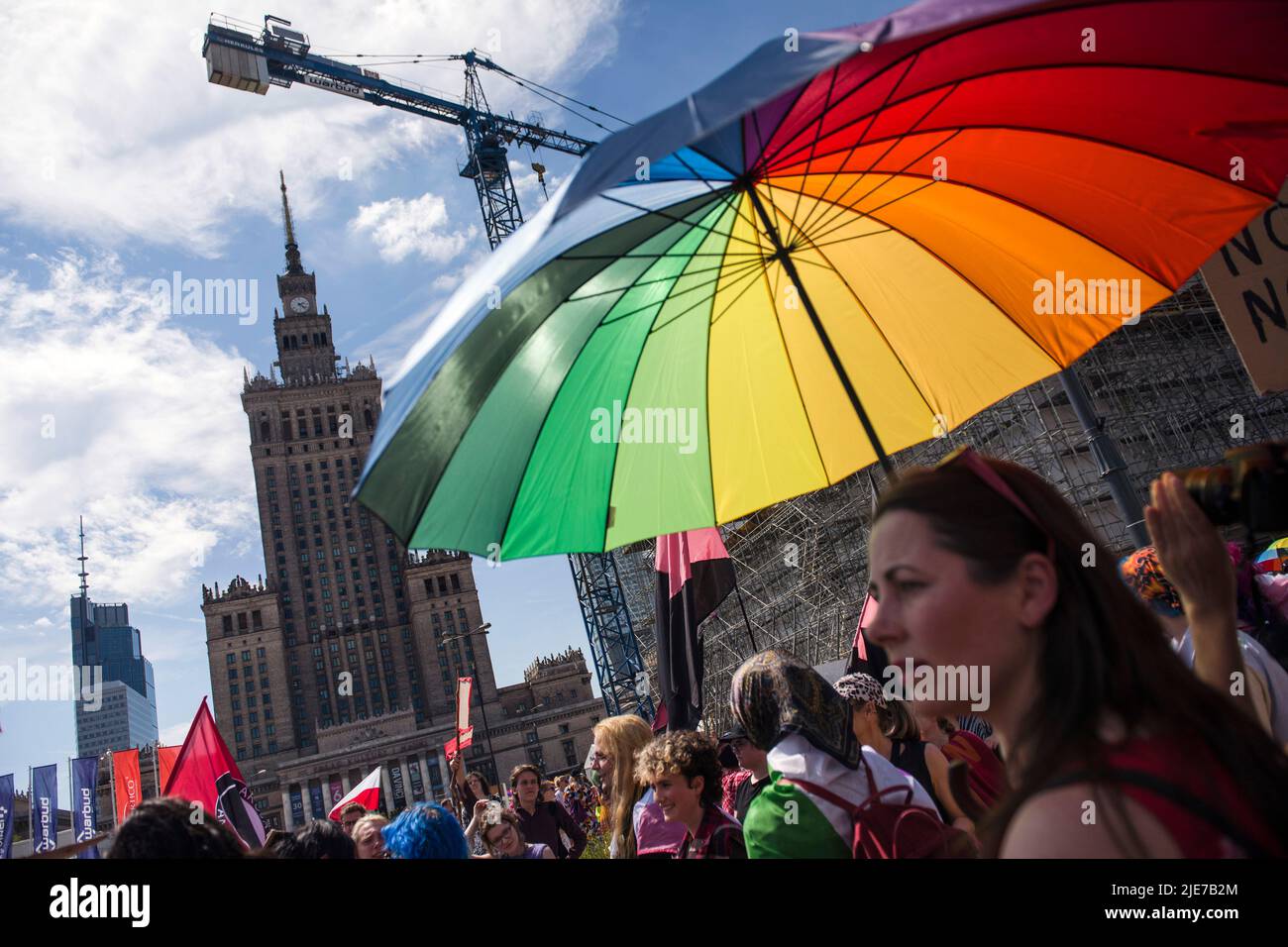 A participant holds a rainbow umbrella during the Warsaw Pride. The ...