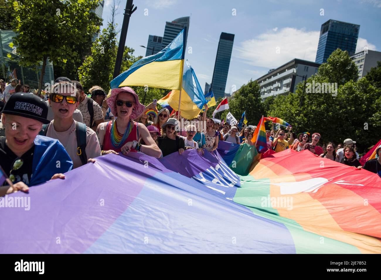 People hold rainbow and Ukrainian flags during the Warsaw Pride. The ...