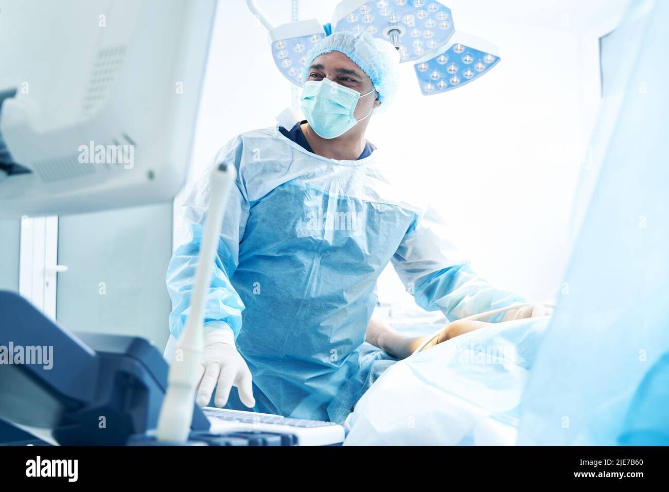 Confident specialist performing ultrasound scanning of the leg Stock ...