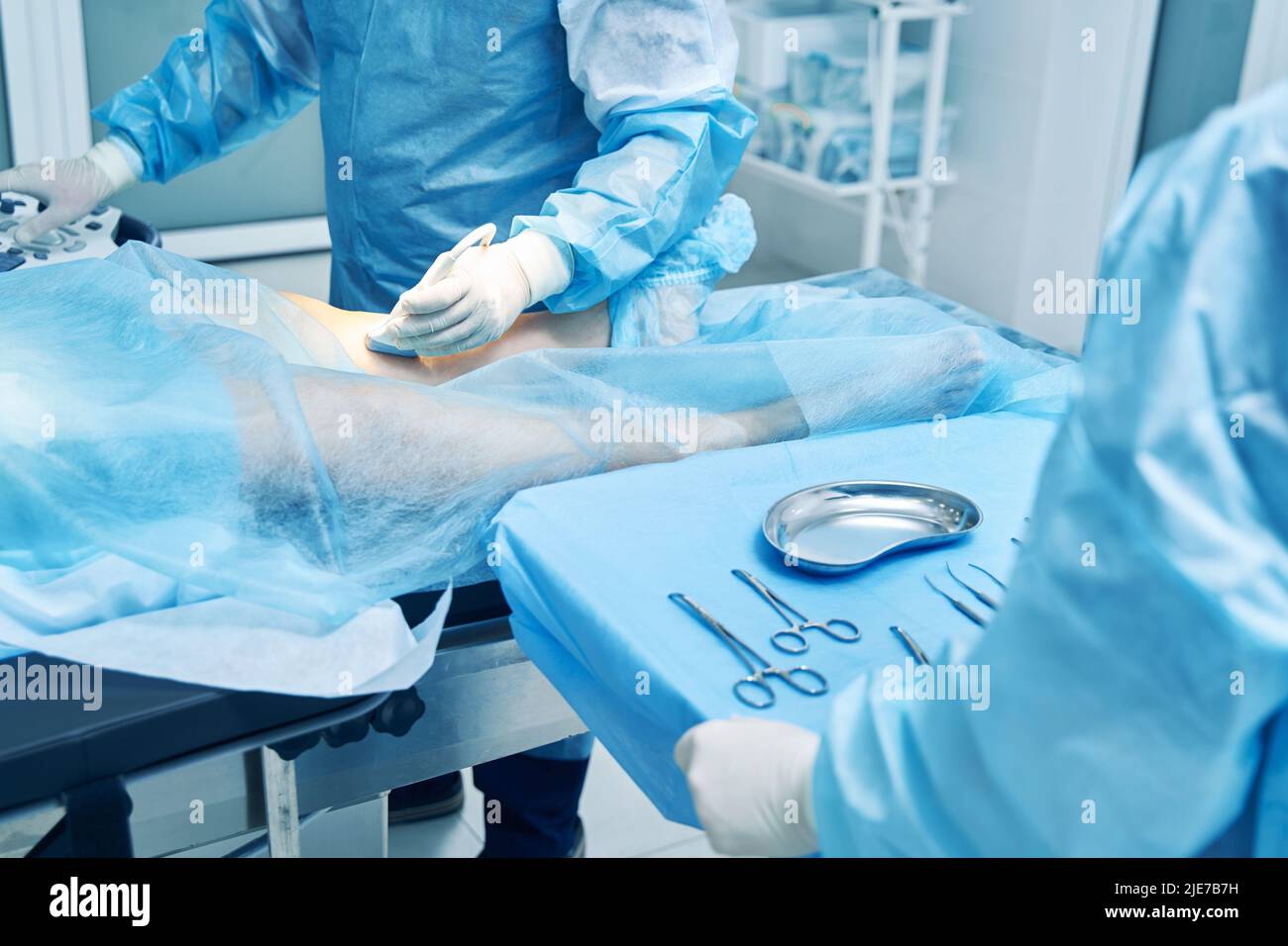Medical workers performing ultrasound examination in clinic Stock Photo ...