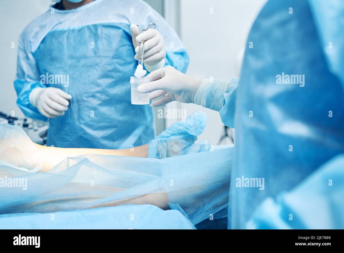 Doctor dipping cotton wool piece into rubbing alcohol Stock Photo - Alamy
