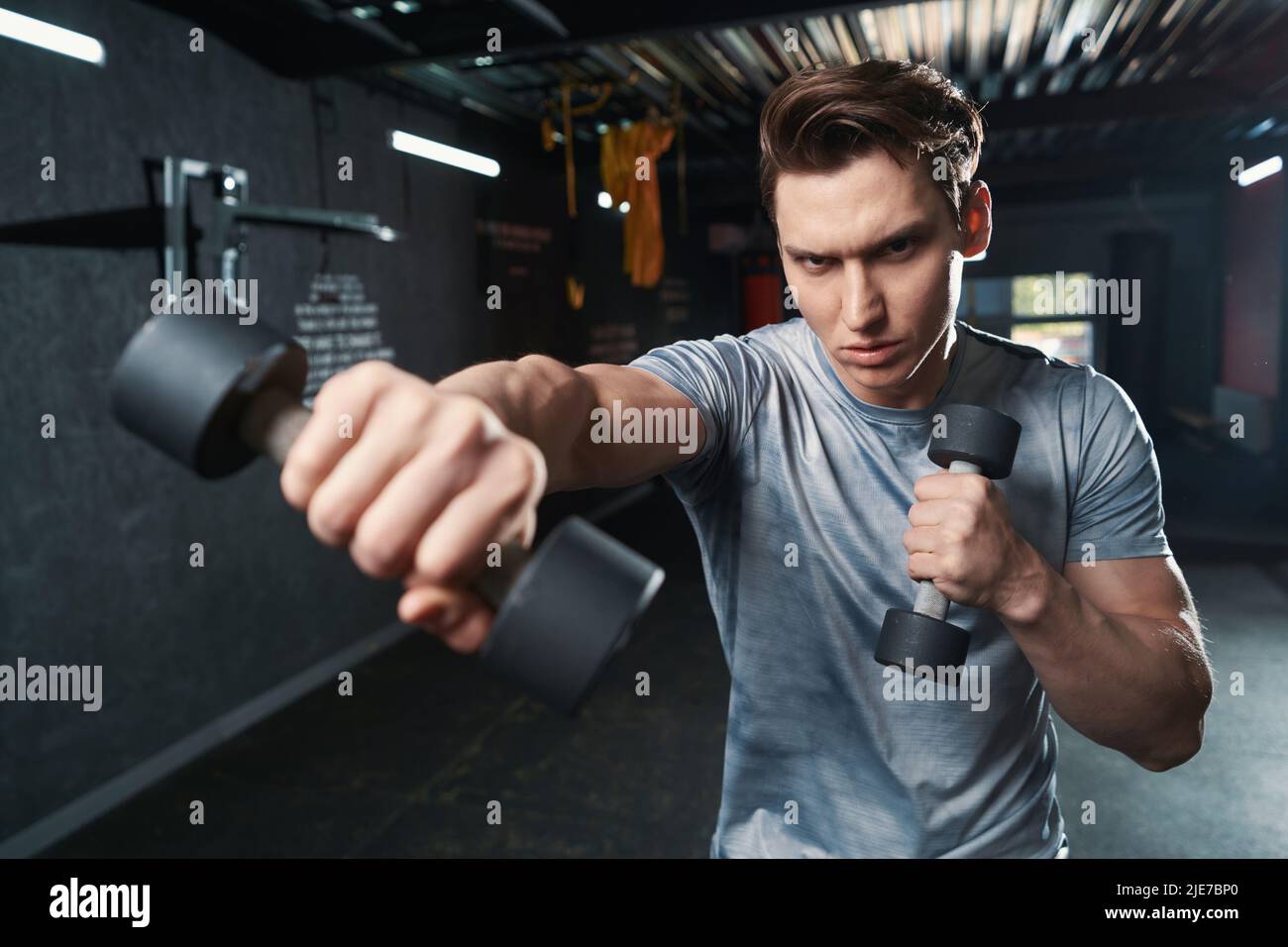 Professional sportsman practicing boxing moves with hand weights Stock ...