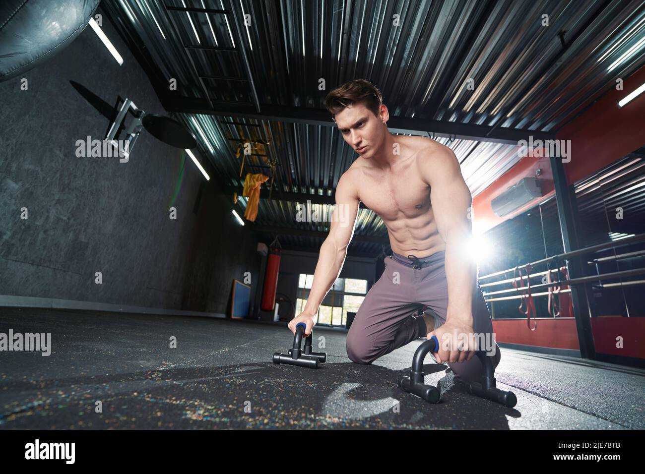 Strong determined male athlete doing strength workout Stock Photo - Alamy