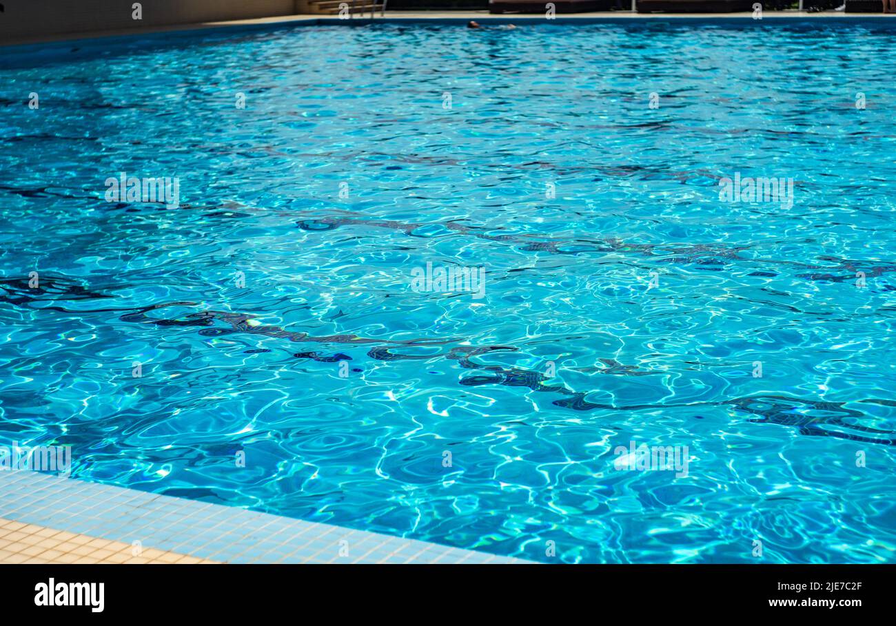 Cool pure blue water in the outdoor pool for relaxing time in summer ...