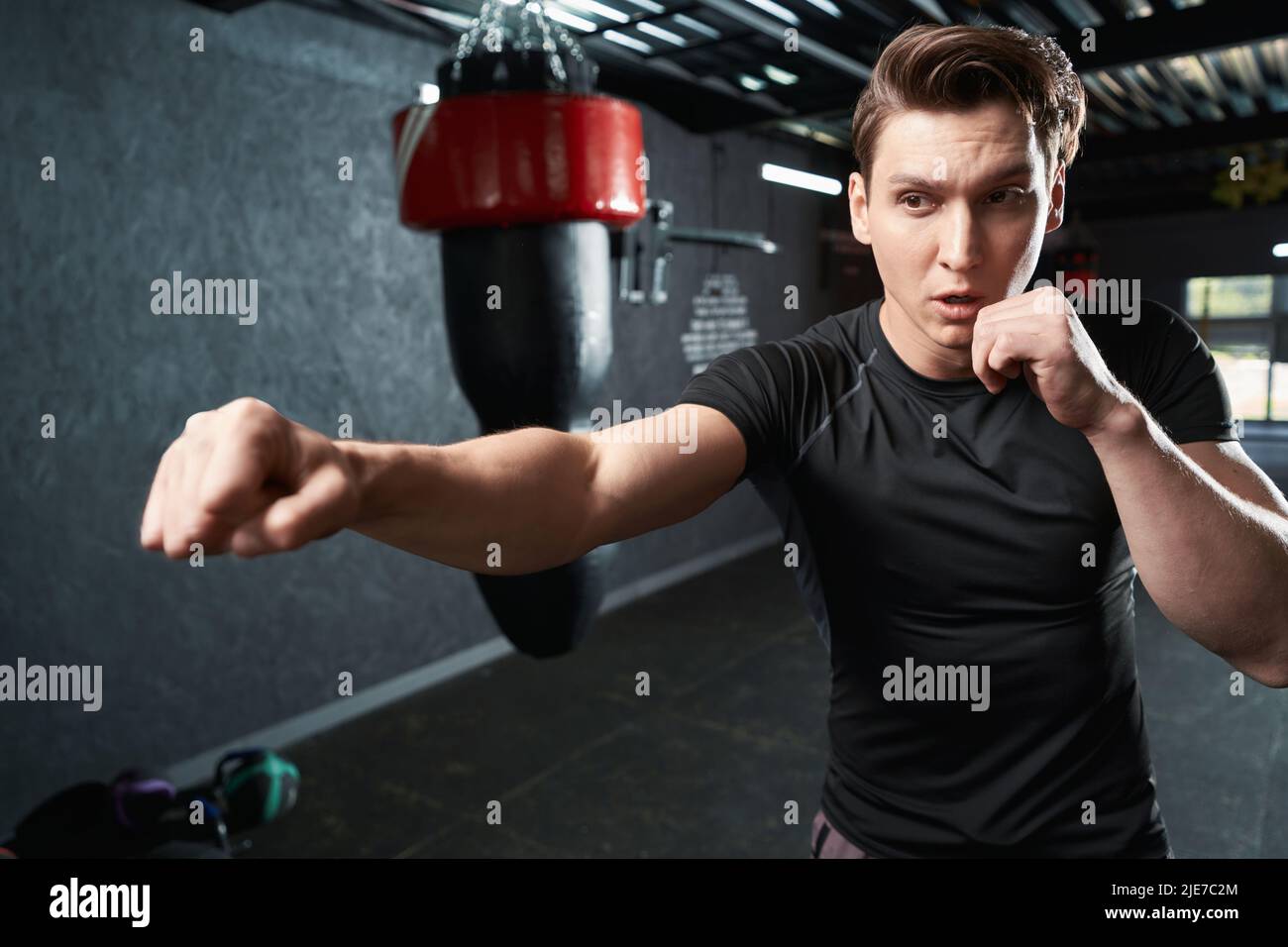 Athletic young man shadow-boxing during gym workout Stock Photo - Alamy