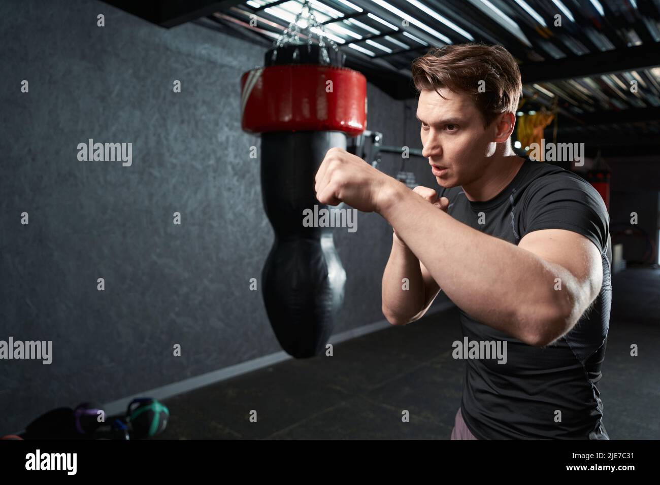 Serious focused male boxer shadow-boxing at gym Stock Photo - Alamy