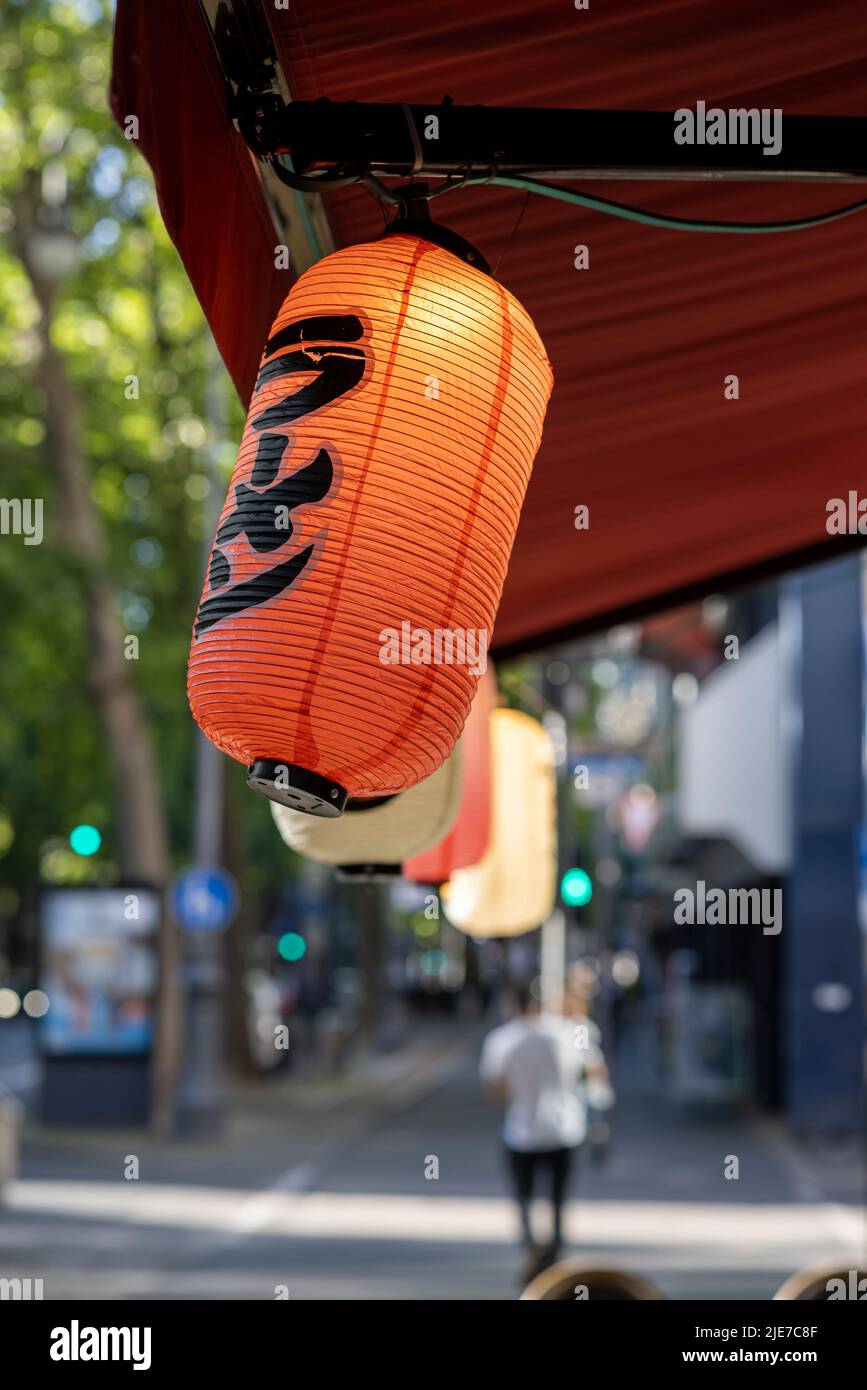 A paper lantern with Japanese writing on a street in Cologne Stock ...