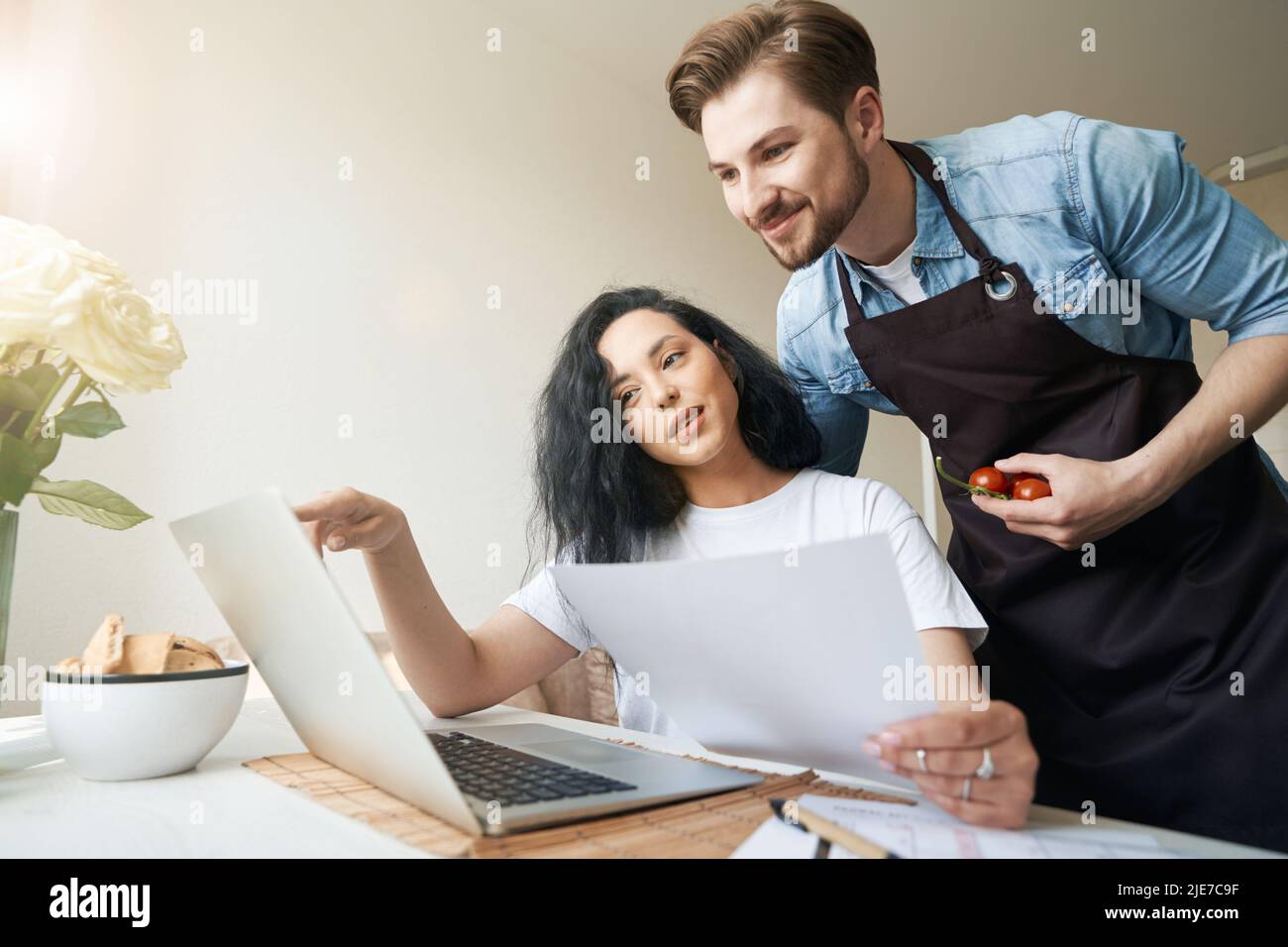 Female and male staring at laptop screen Stock Photo - Alamy
