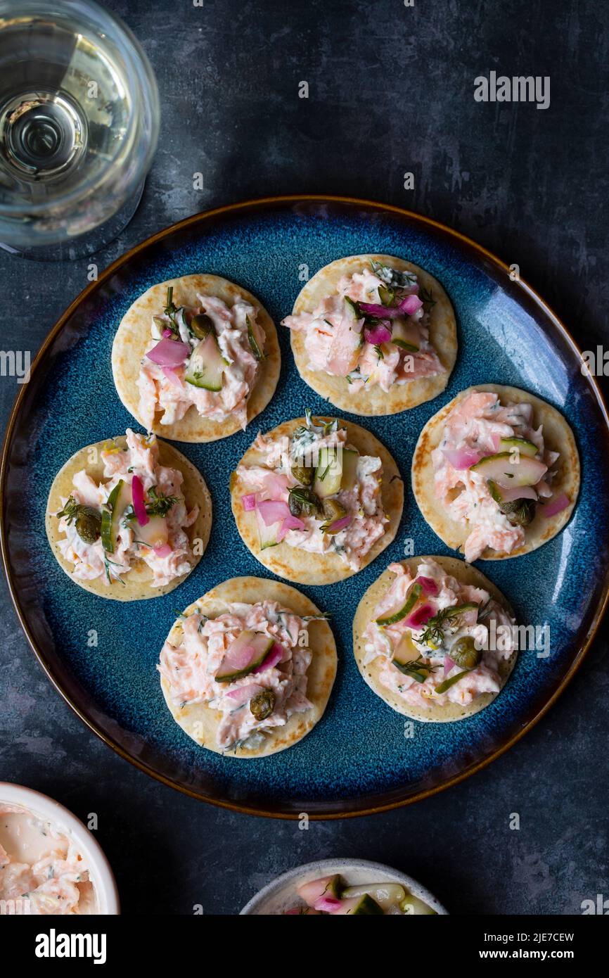 Party canapes, blinis with salmon spread Stock Photo - Alamy
