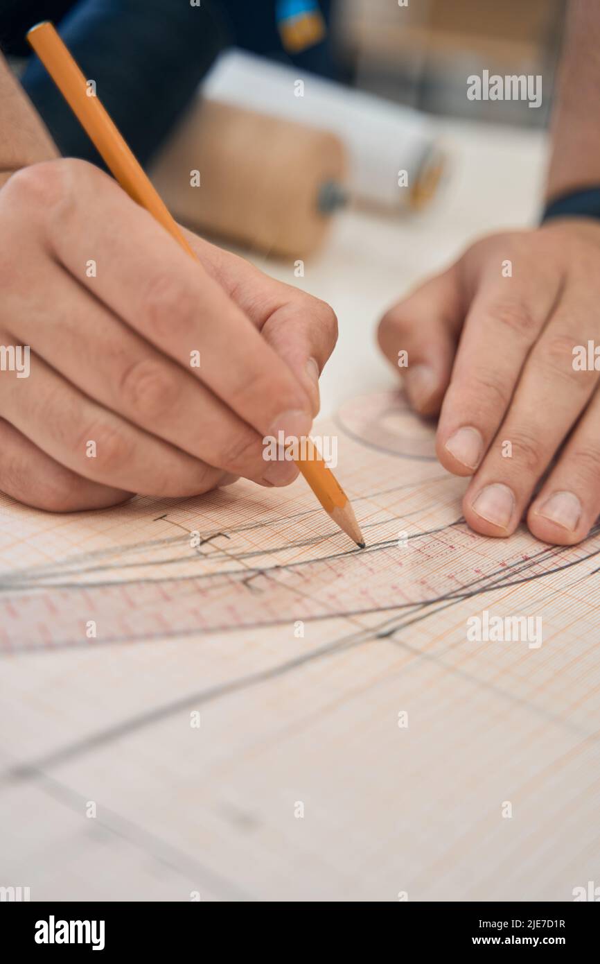 Fashion designer making patterns for new clothes Stock Photo - Alamy