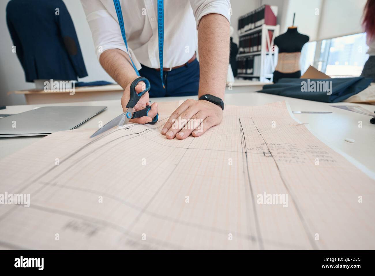 Male tailor making sketches of new clothes Stock Photo - Alamy
