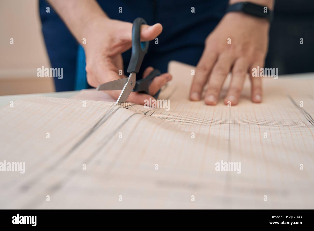 Tailor preparing patterns for dress making in atelier Stock Photo - Alamy