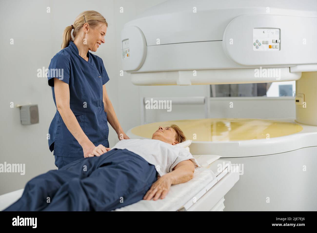 Radiologist controls MRI or CT or PET Scan with female patient ...