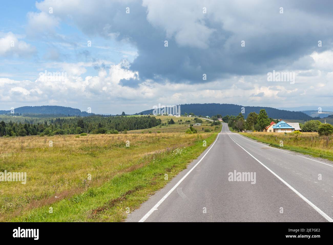 Countryside summertime landscape with valleys and grassy hills. Fluffy ...