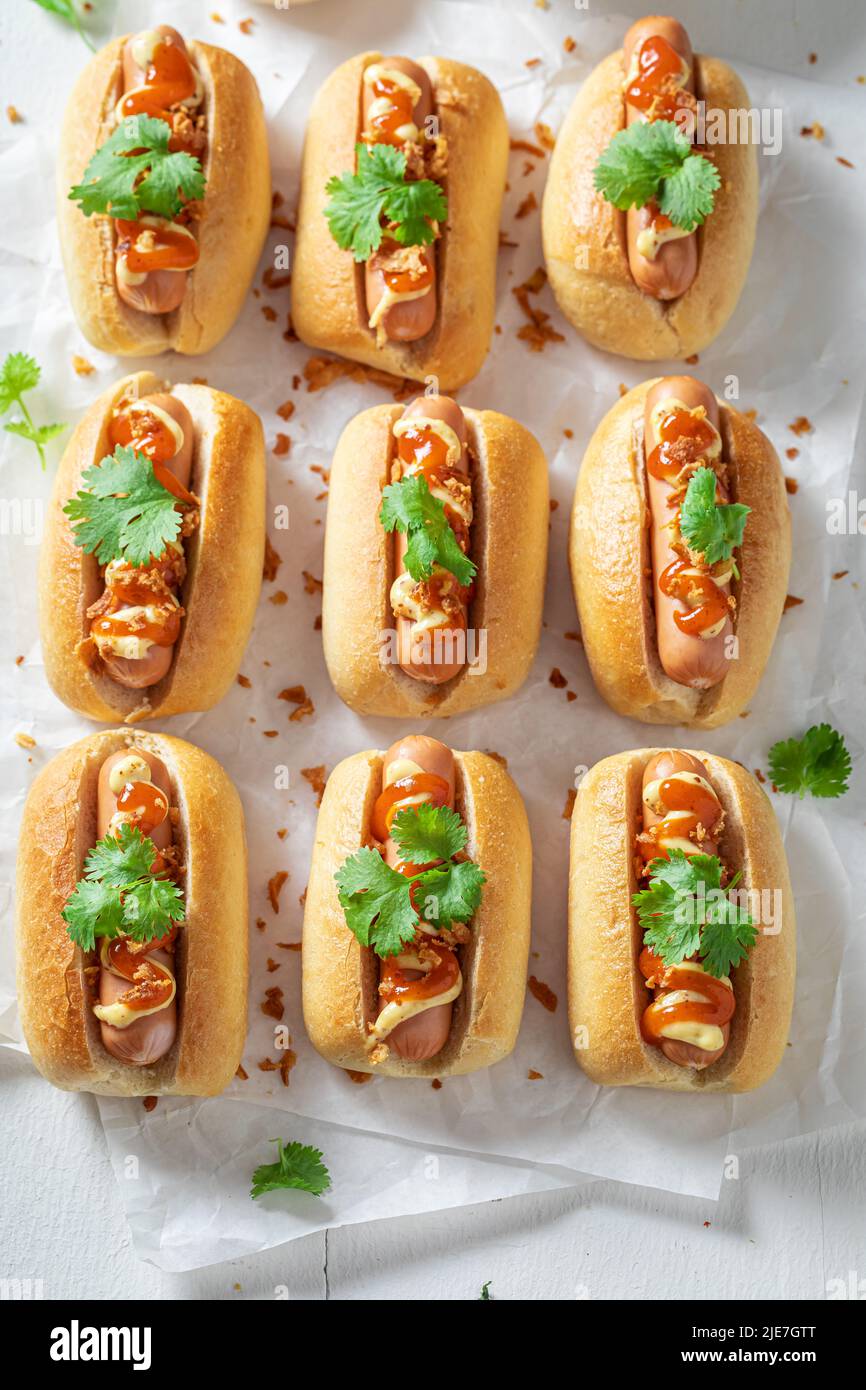 Hot and homemade mini hot dogs as fast food. Mini hot dogs with spicy ...