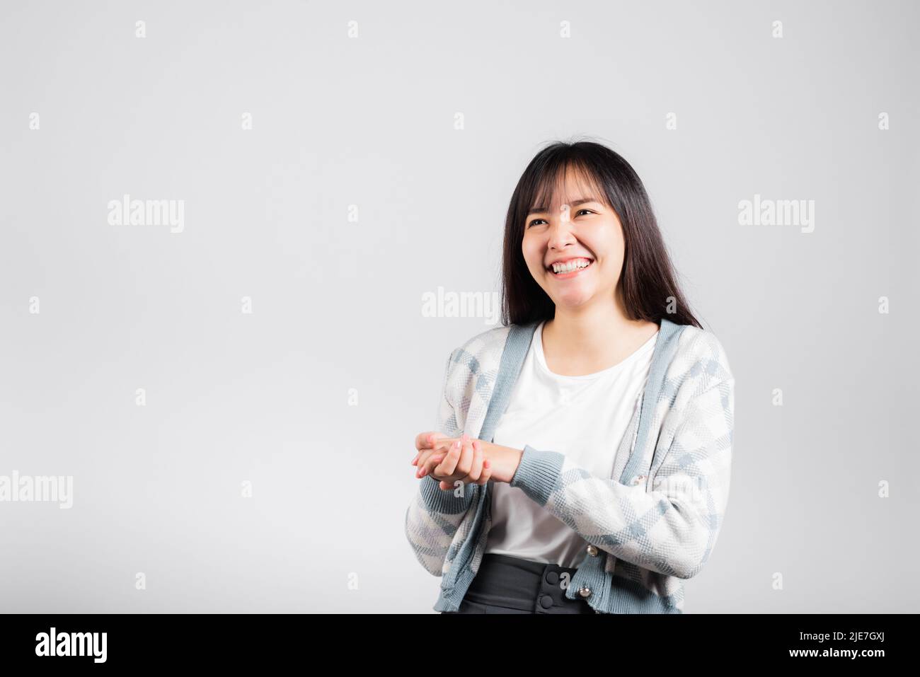 Woman winning and surprised excited screaming laughing studio shot ...