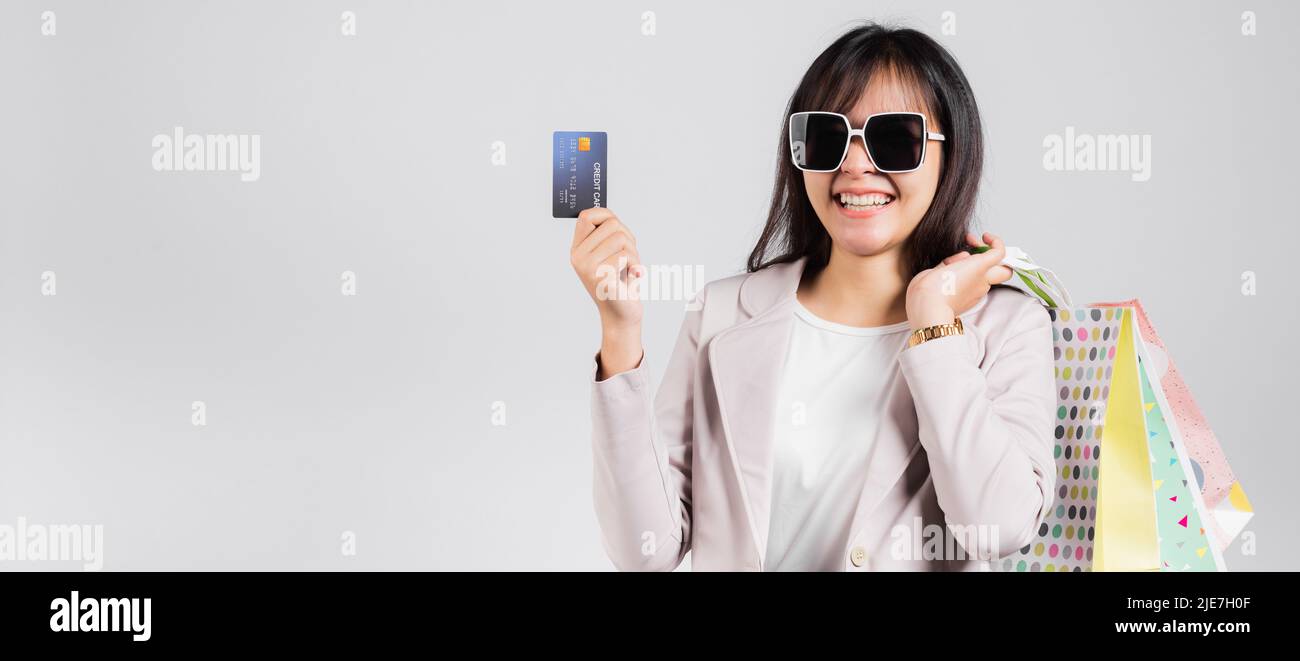 Woman with glasses confident shopper smile hold online shopping bags ...