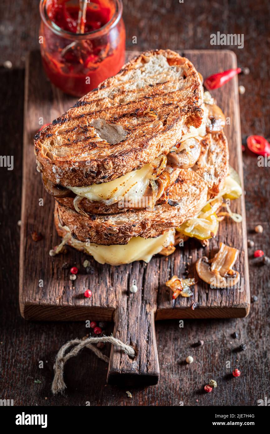 Crunchy and spicy toasts with spicy sauce, onion and grilled cheese ...