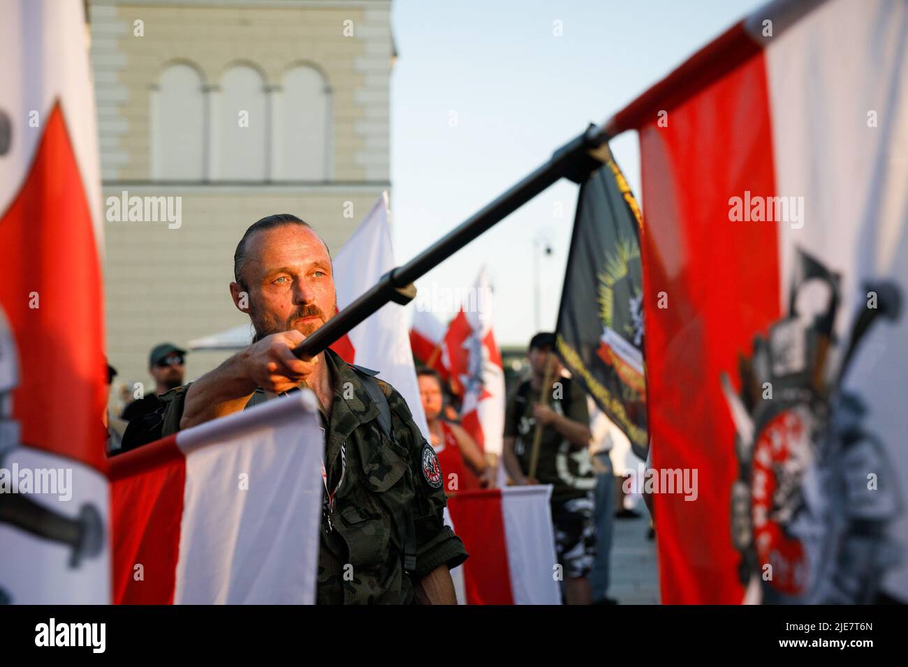 Warsaw, Poland. 25th June, 2022. A demonstrator holds a flag at half ...