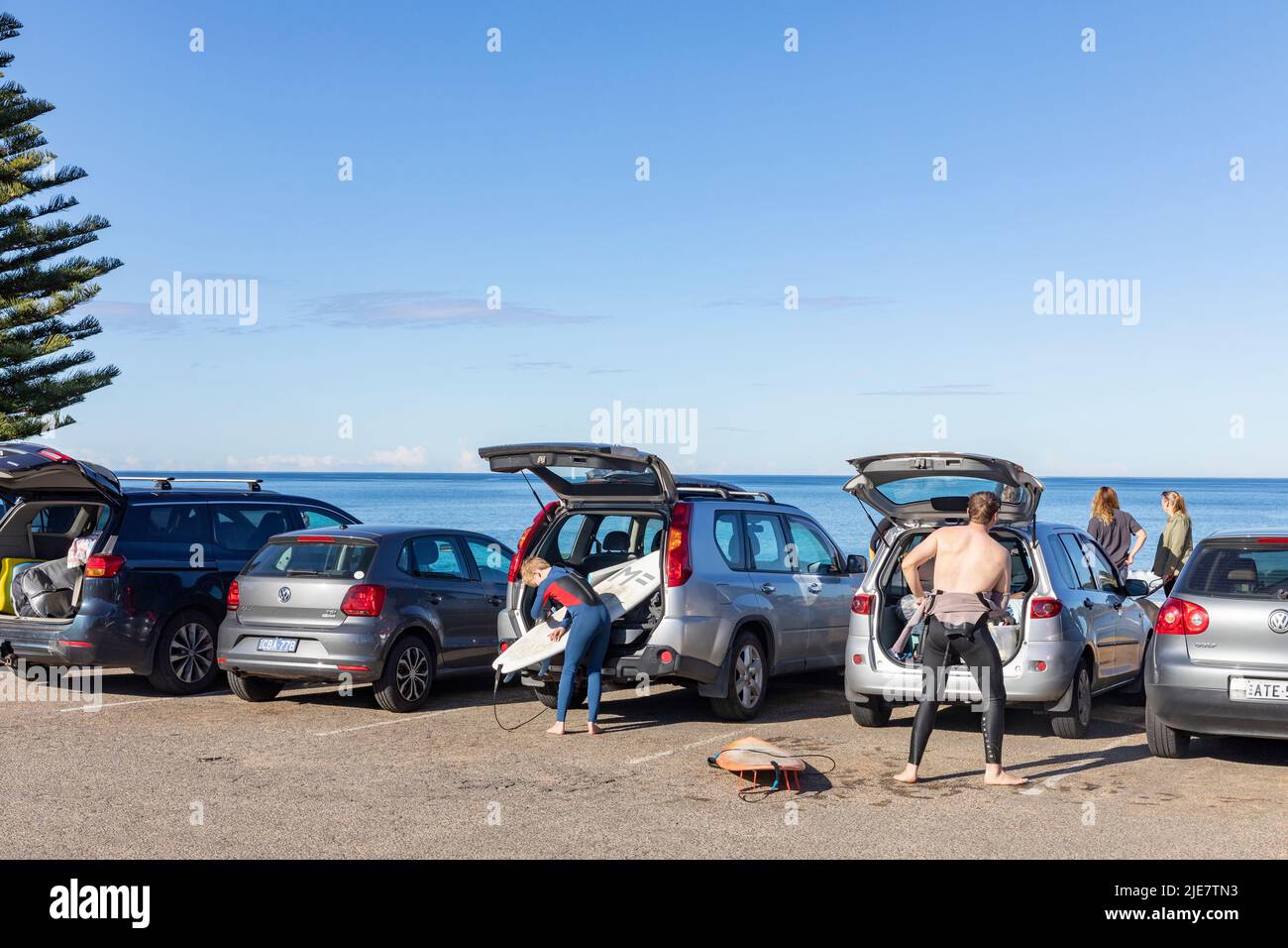 Australian surfer at Avalon Beach Sydney changing into his wetsuit to ...