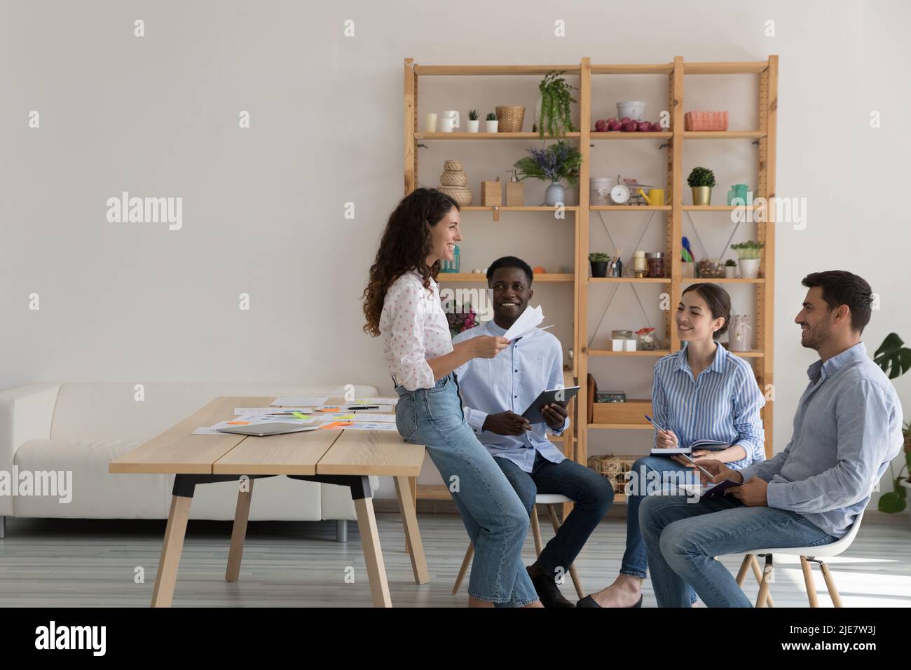 Team of ambitious corporate staff communicate in office during briefing ...