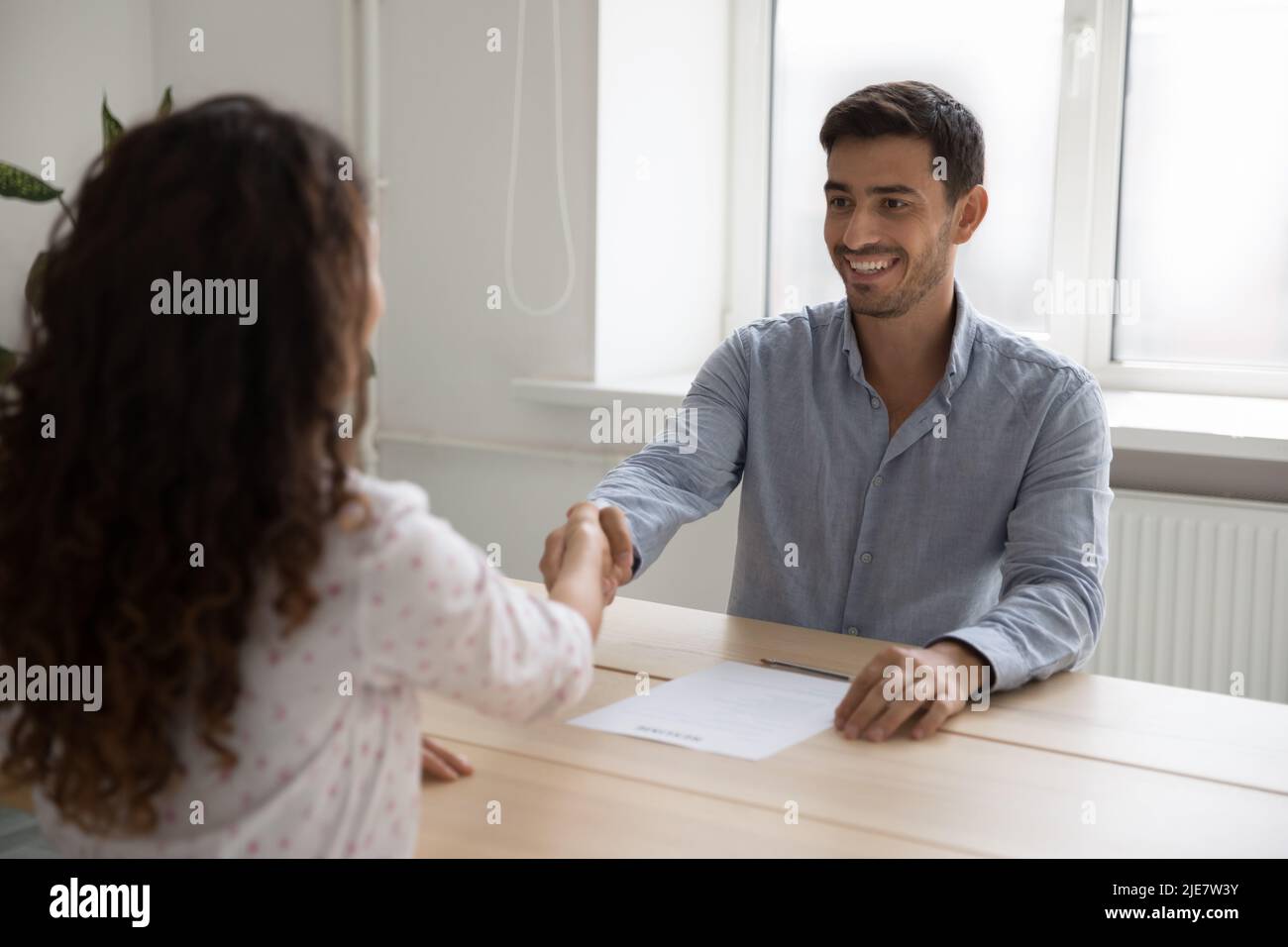 Hispanic businessman shake hands female applicant during successful job ...