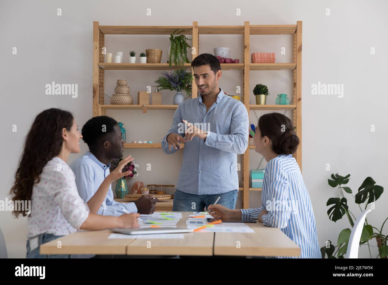Diverse team take part in meeting, listening company boss Stock Photo ...