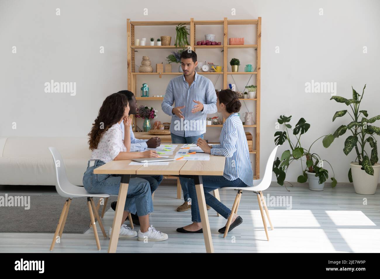 Diverse team take part in group meeting in boardroom Stock Photo - Alamy