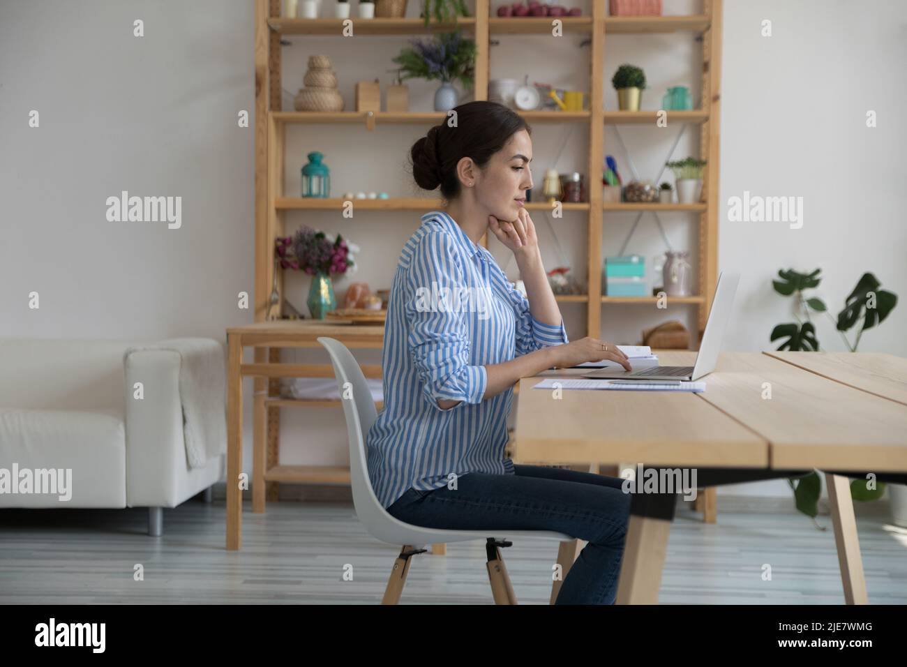 Focused businesswoman sit at desk working use laptop Stock Photo - Alamy