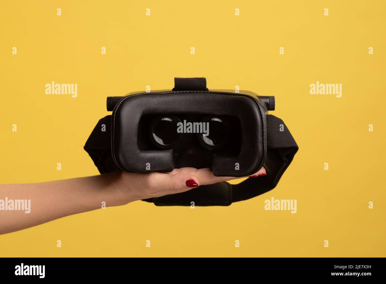 Side view of woman hand holding VR goggles, virtual reality 3d glasses ...