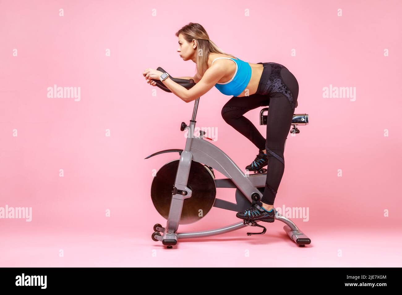 Side view of woman working out on fitness at home, training on ...