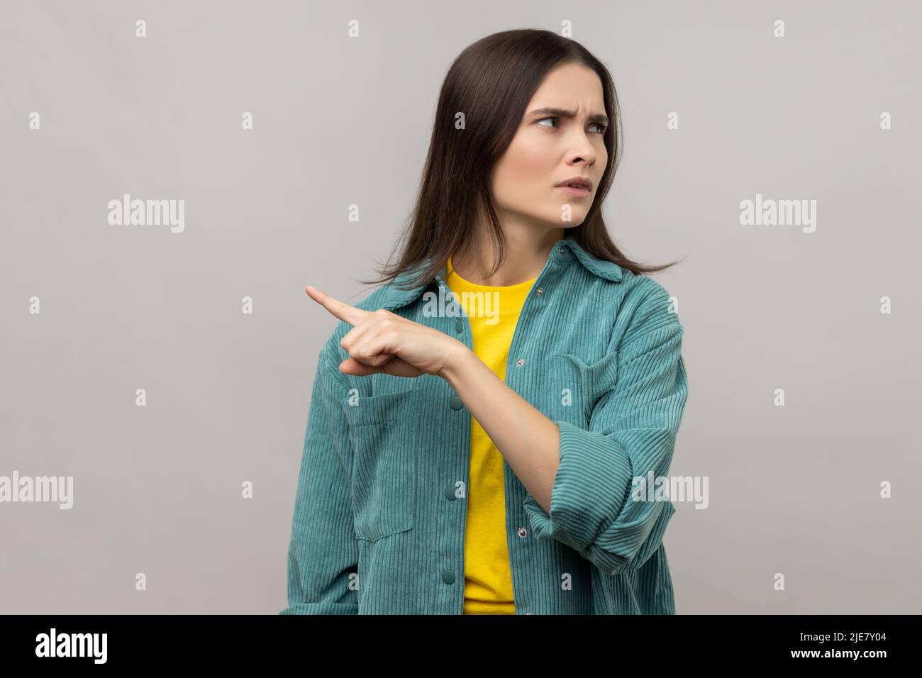 Get out. Portrait of upset vexed woman with dark hair showing exit ...
