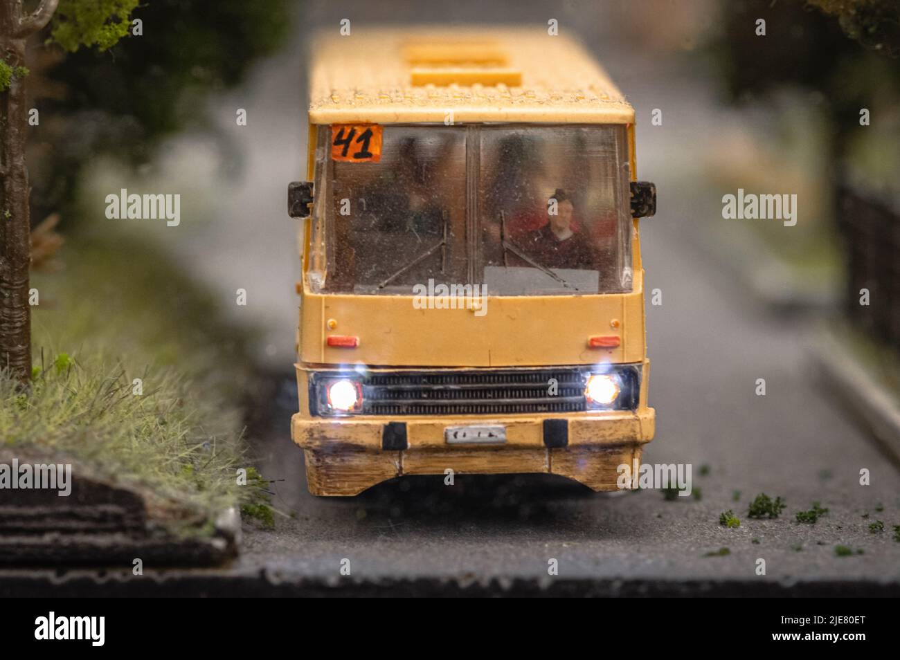 Toy representation of a classic yellow bus Stock Photo - Alamy