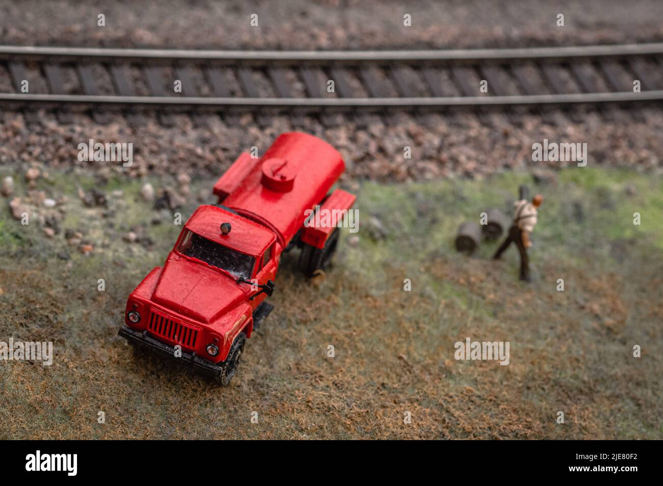 Toy representation of a red truck near the railways Stock Photo - Alamy