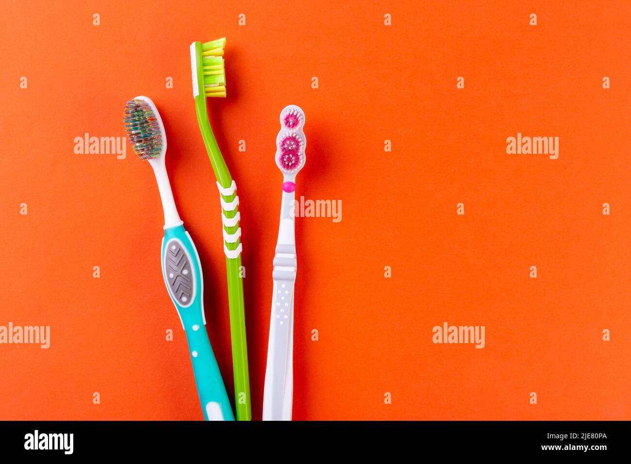 Toothbrushes on a orange background. Concept toothbrush selection. Oral ...