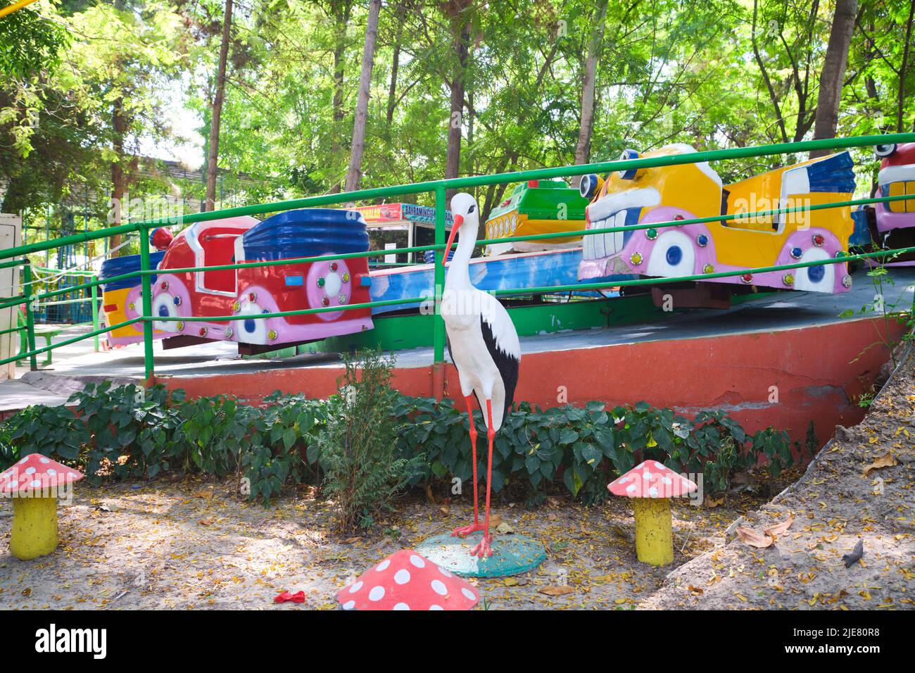 A sculpture of a stork, egret, ibis bird in front of an amusement park ...
