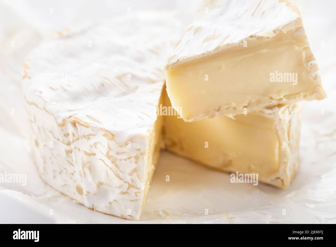 Brie type of cheese. Close up on Camember cheese. Pieces of soft cheese ...