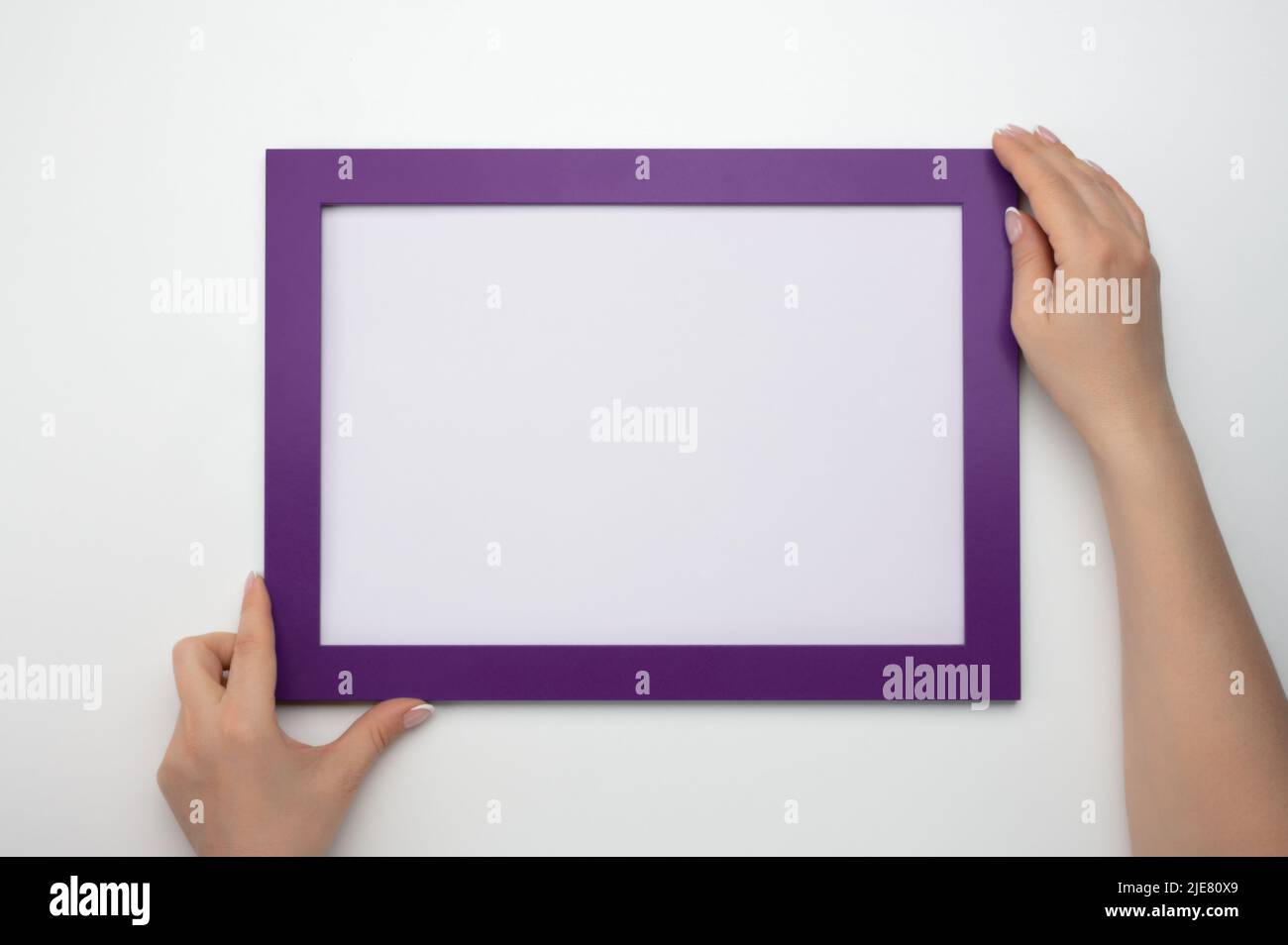 Holding frame mockup. Photo Mockup. Woman hands hold purple frame. For ...