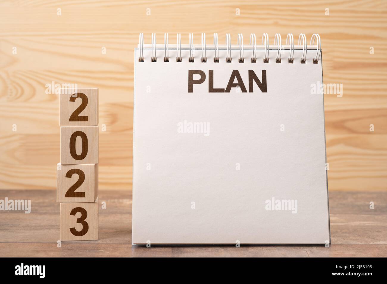 Mockup 2023 notepad with PLAN text. Text 2023 on wooden cubes. space ...