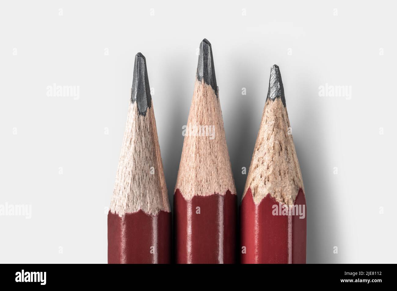 three sharpened pencils close up isolated on white background. Pencil ...