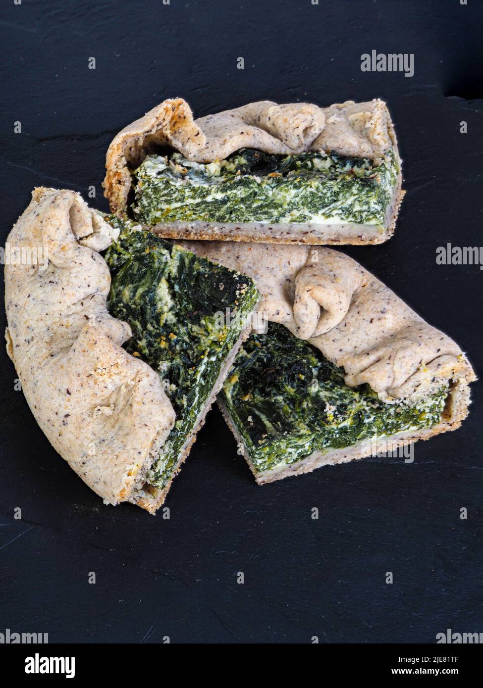 Homemade spinach and cheese small pie in slices for 1 person Stock ...