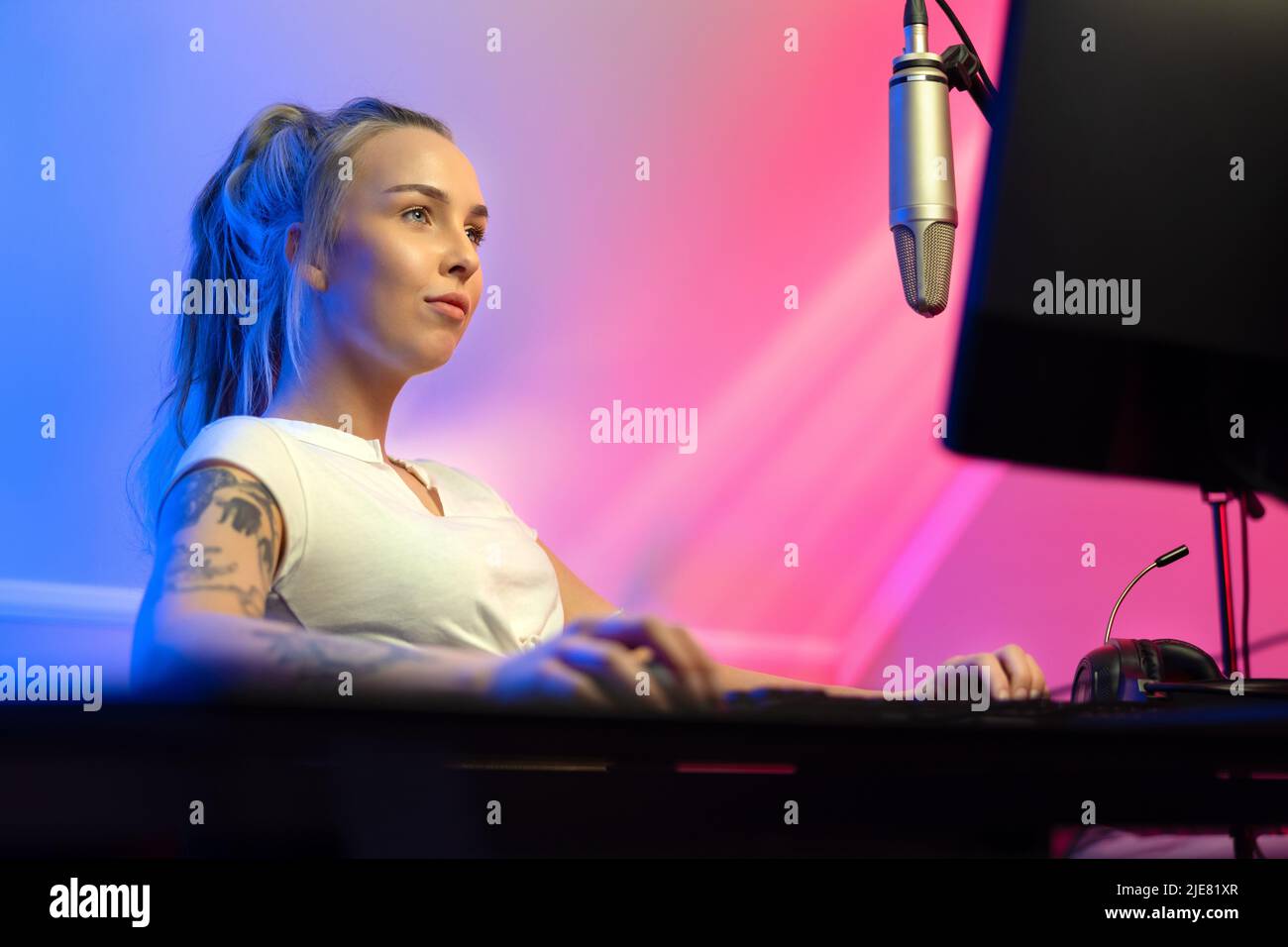 Focused professional gamer girl streams and play online multiplayer ...